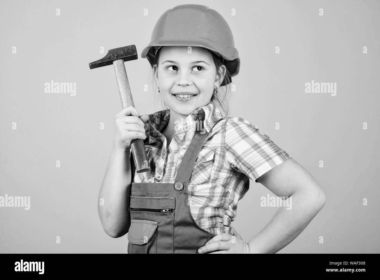 small girl repairing with hammer in workshop. Future profession ...