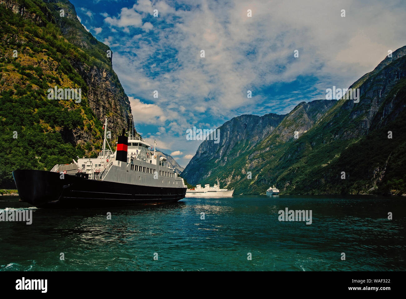Ships in sea on mountain coast in Homersfag, United Kingdom. Cruise ...