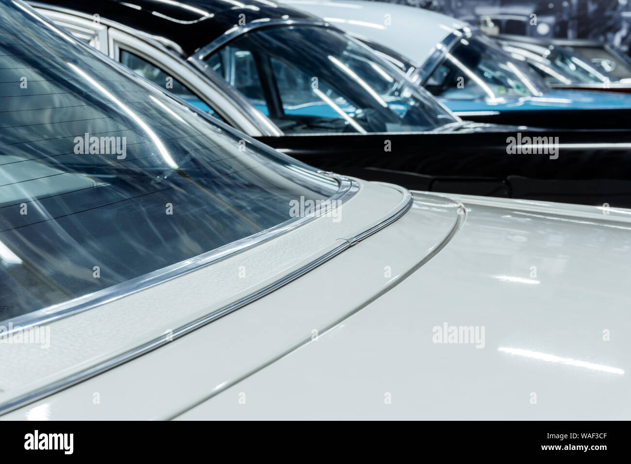 row of vintage cars standing in the background of cityscape, rear view ...