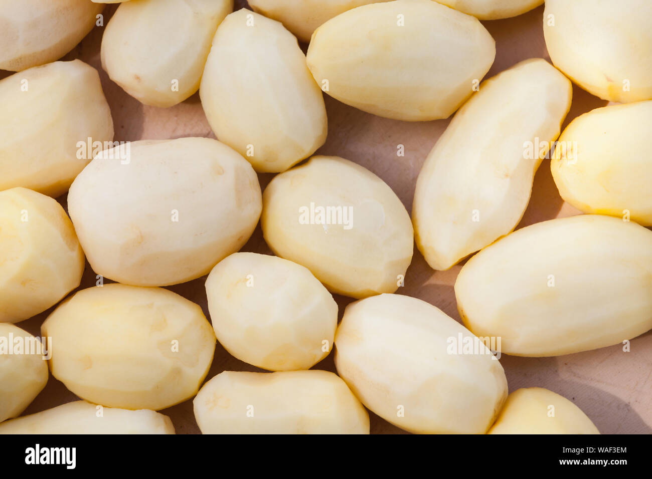 Fresh peeled potatoes lay on a table, top view Stock Photo - Alamy