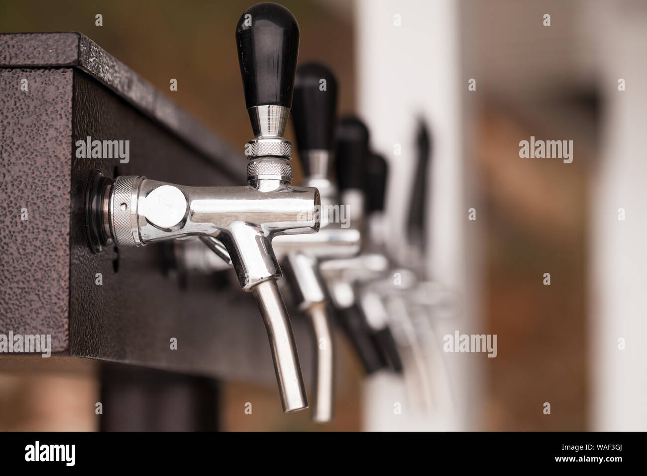 Modern beer taps in a row, close up photo with soft selective focus ...