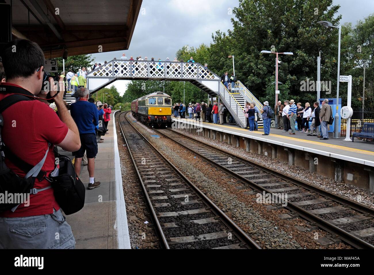 Railway enthusiasts photographing a railway excursion train at ...