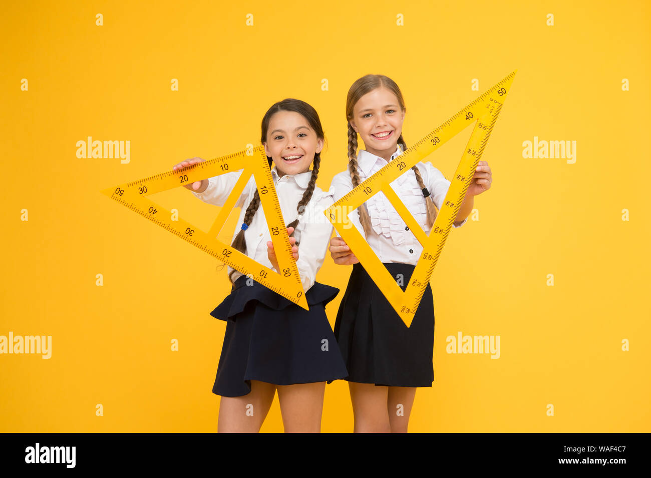 Pupil school girls big rulers. School knowledge. Explore world with ... Pupil school girls big rulers. School knowledge. Explore world with ...