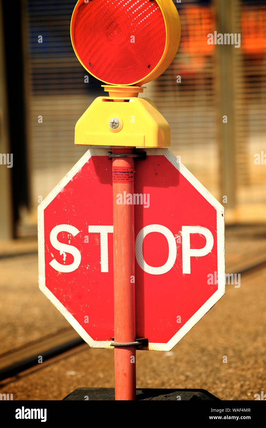 Stop sign on track in front of gates at tram depot Stock Photo - Alamy