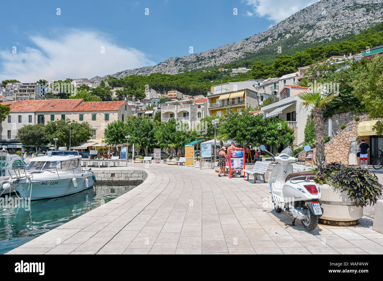 The harbor in Brela. The location on the Makarska riviera in Croatia is ...