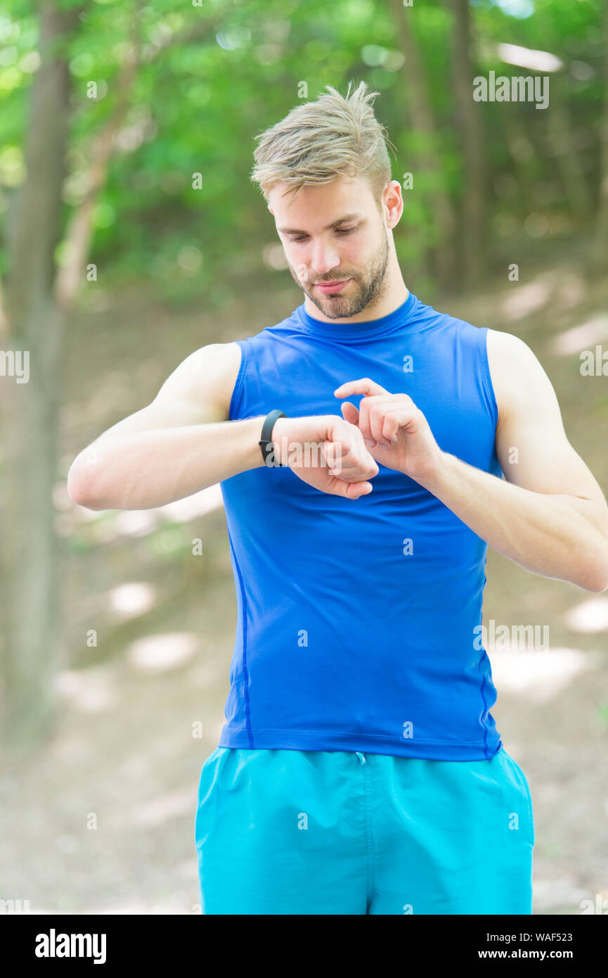 Time to start. Handsome sportsman in sportswear outdoors. Active ...