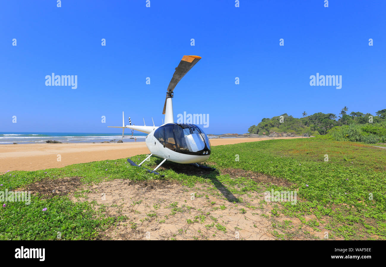 White helicopter on the beach Stock Photo - Alamy