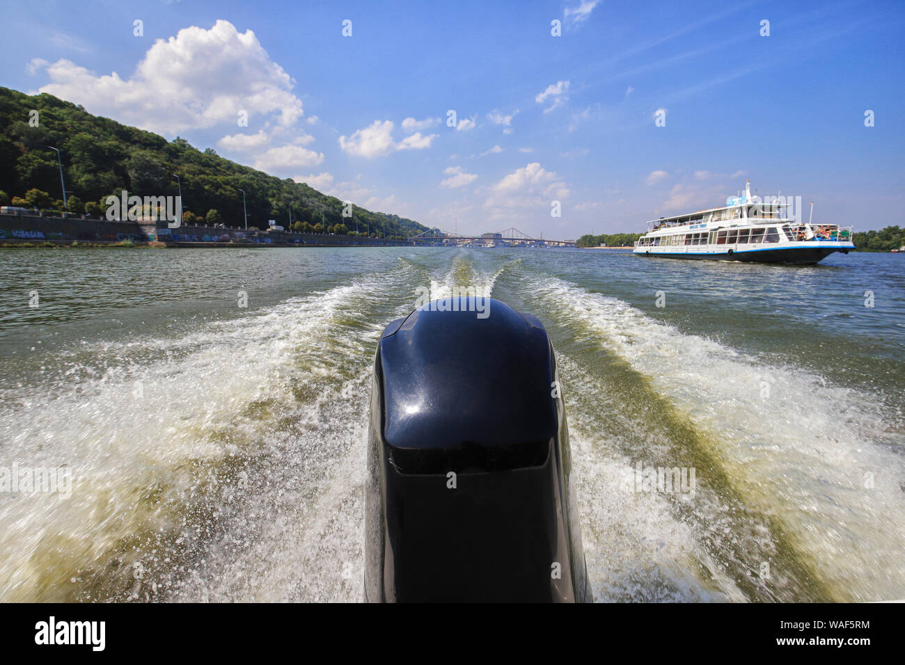 Rear view of motor speed boat with water wake foam trace behind the ...