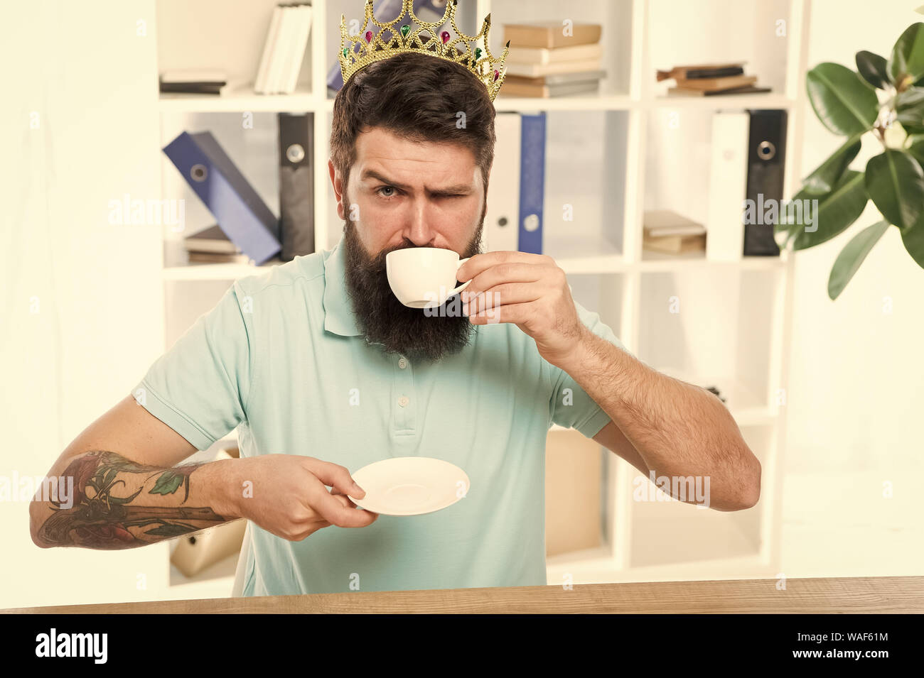 Relaxed top manager drinking coffee. Confident boss enjoying his glory ...