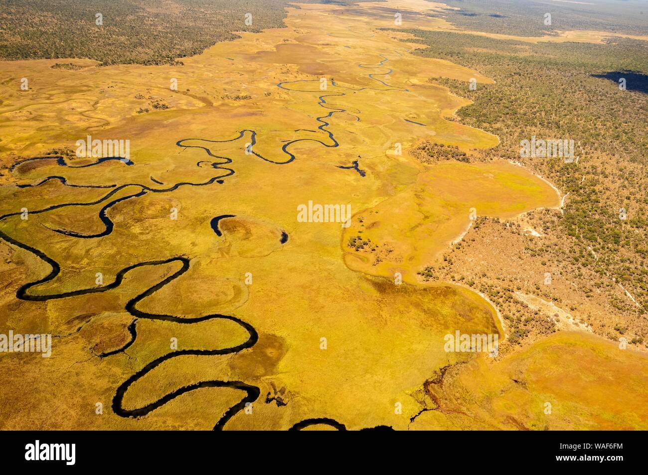 Aerial view, Cubango river meanders through grass savannah, near Cuito ...