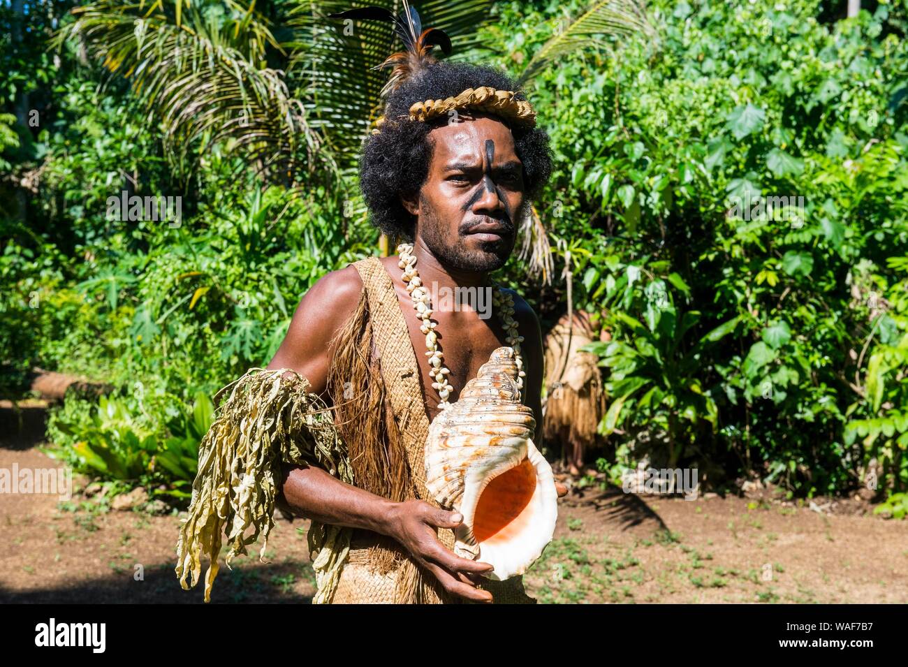 Man with a giant shell, Ekasup cultural village, Efate, Vanuatu Stock ...