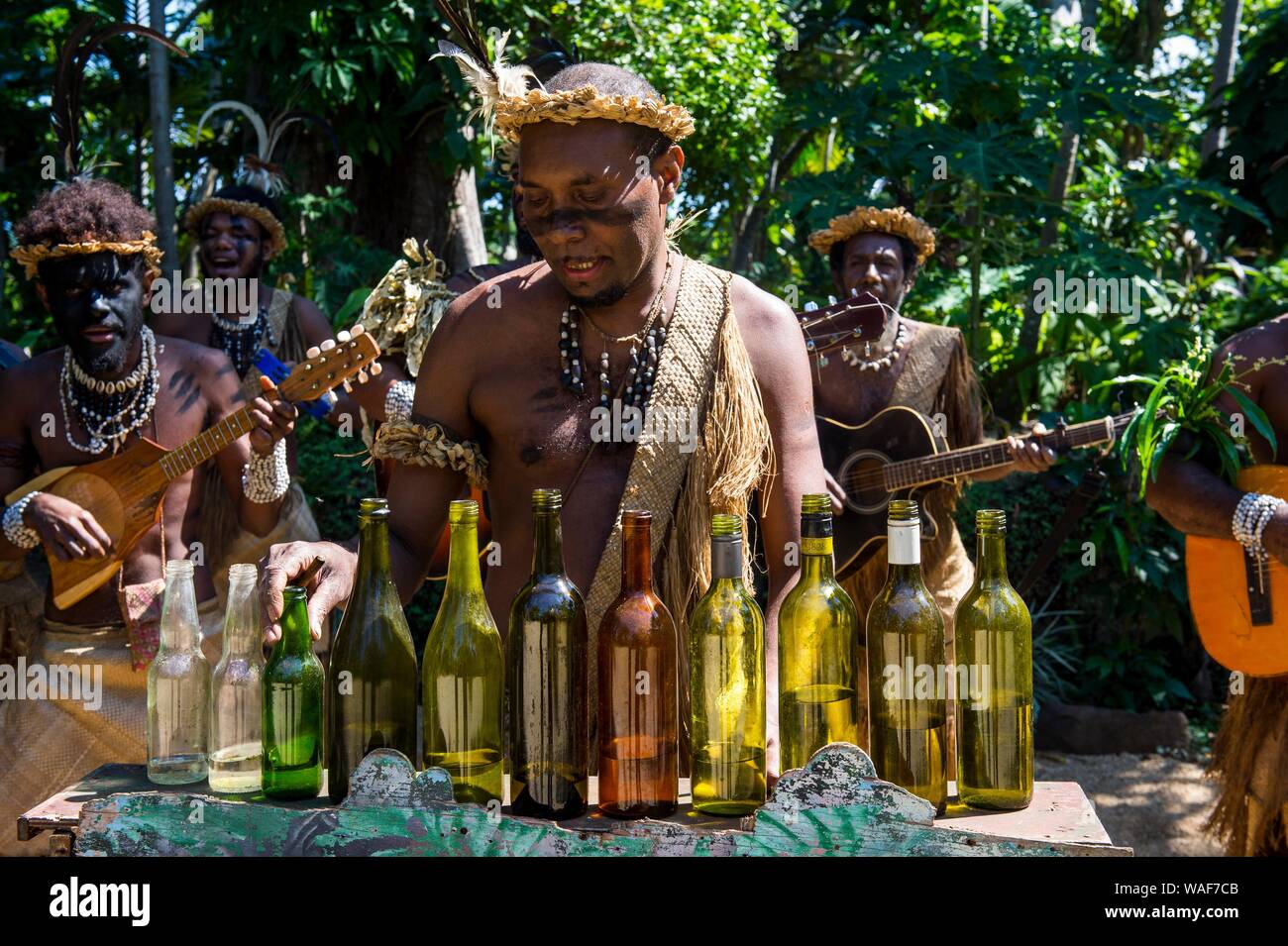 Group of traditional dressed men playing music, Ekasup cultural village ...