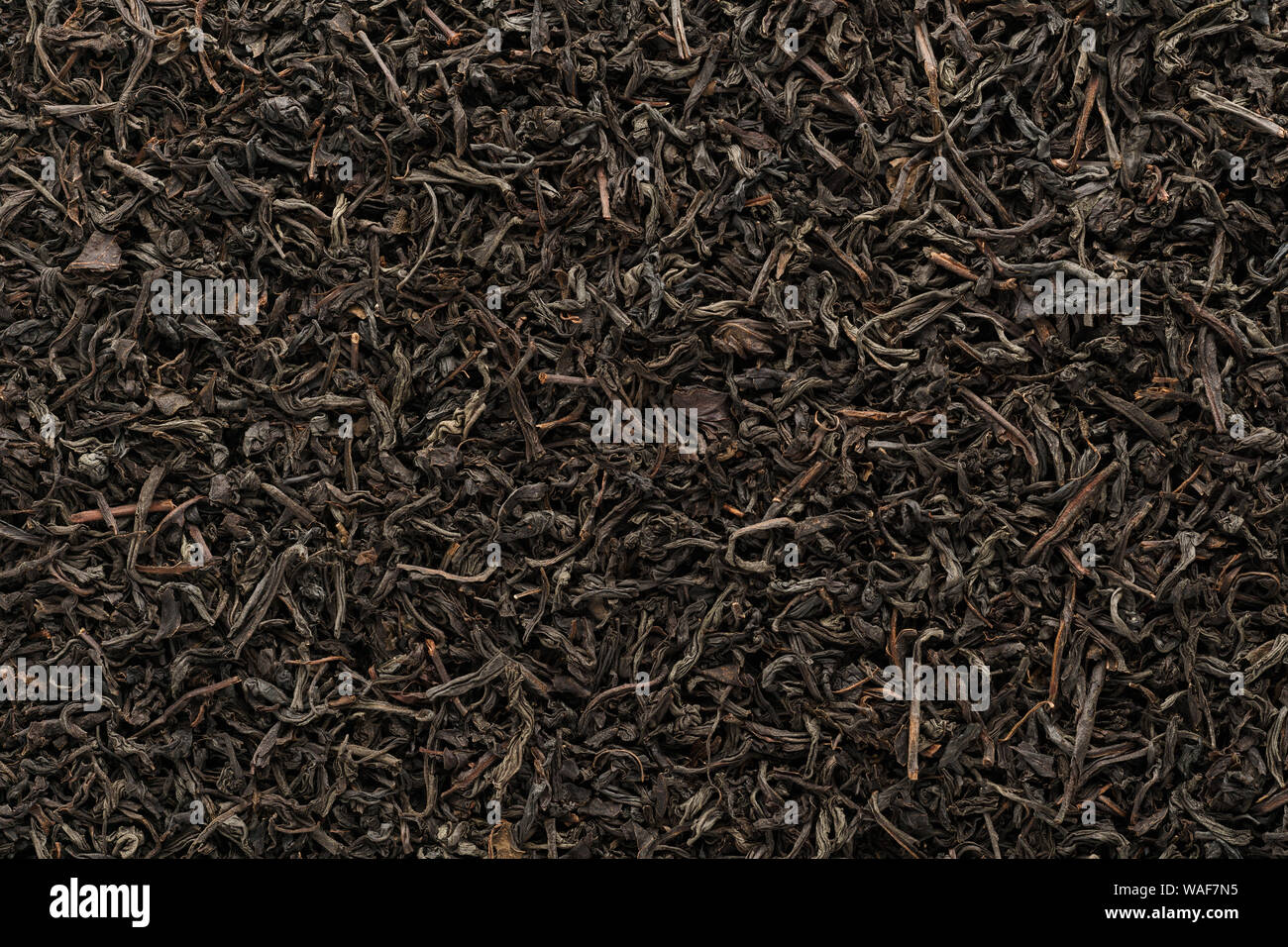 Dry black tea leaves as a background. Shot from above Stock Photo - Alamy