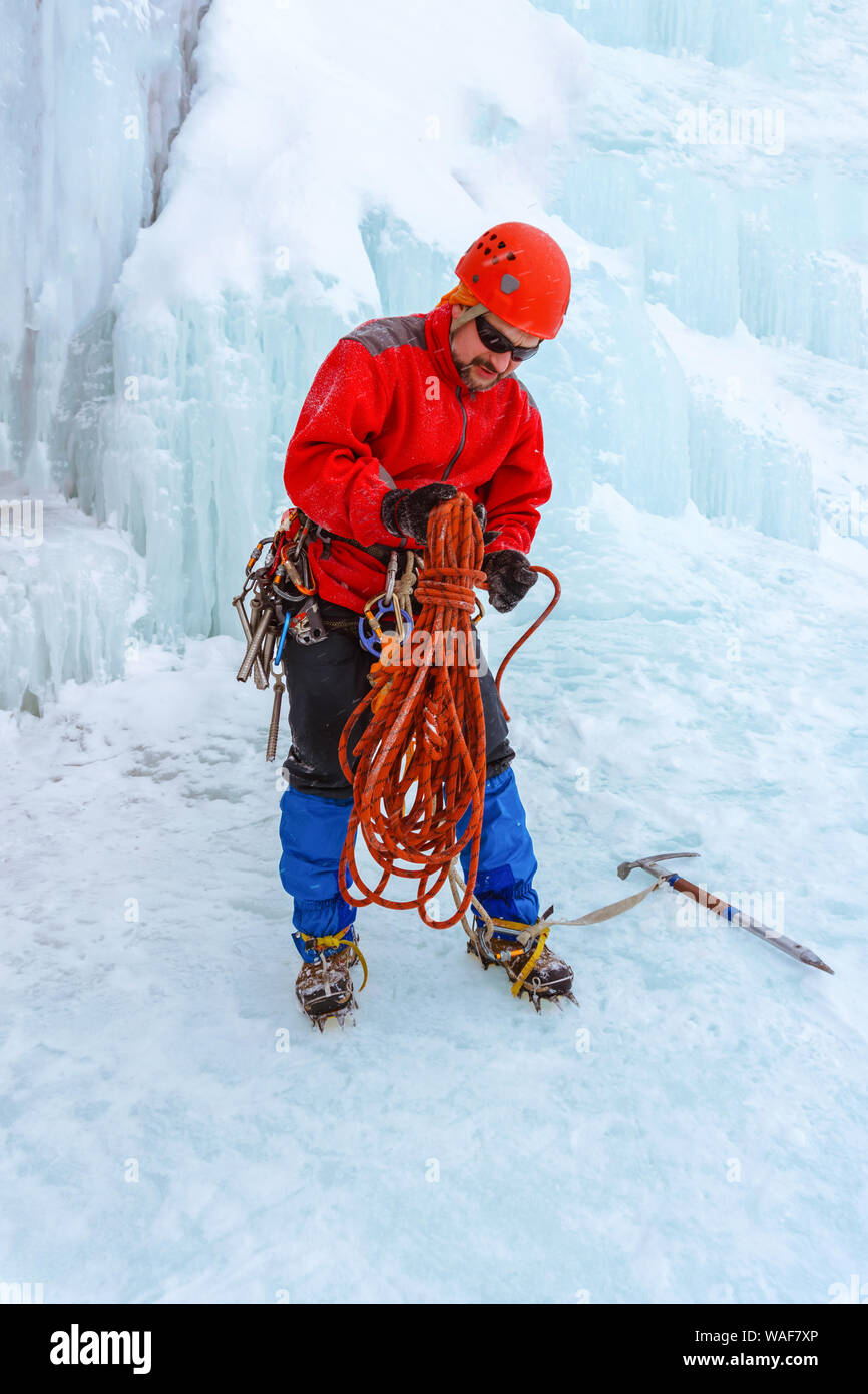 Man preparing to climb frozen waterfall hi-res stock photography and ...