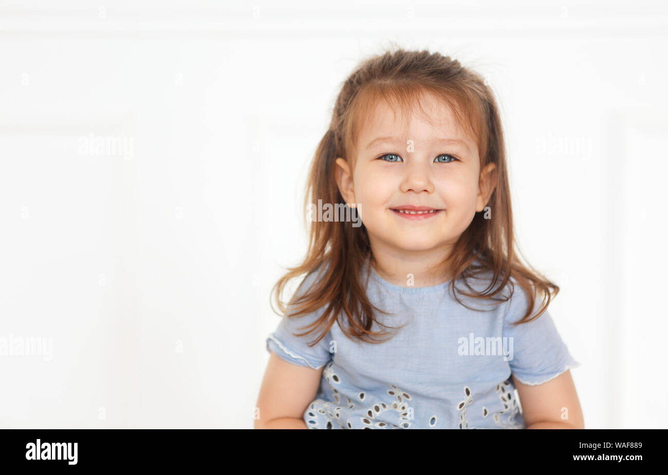 Cute little redhaired girl with blue eyes in denim jeans and blue shirt ...