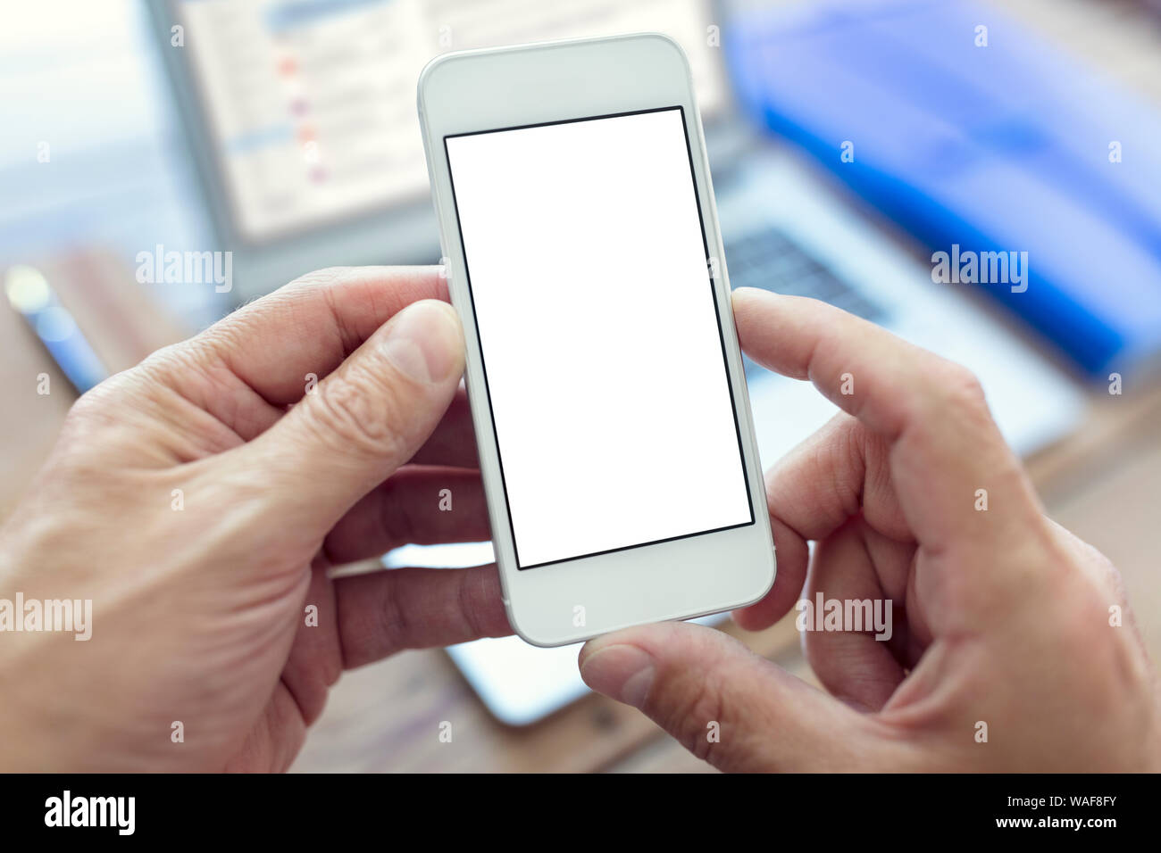 Mobile smartphone with blank white screen holding in man hand Stock ...