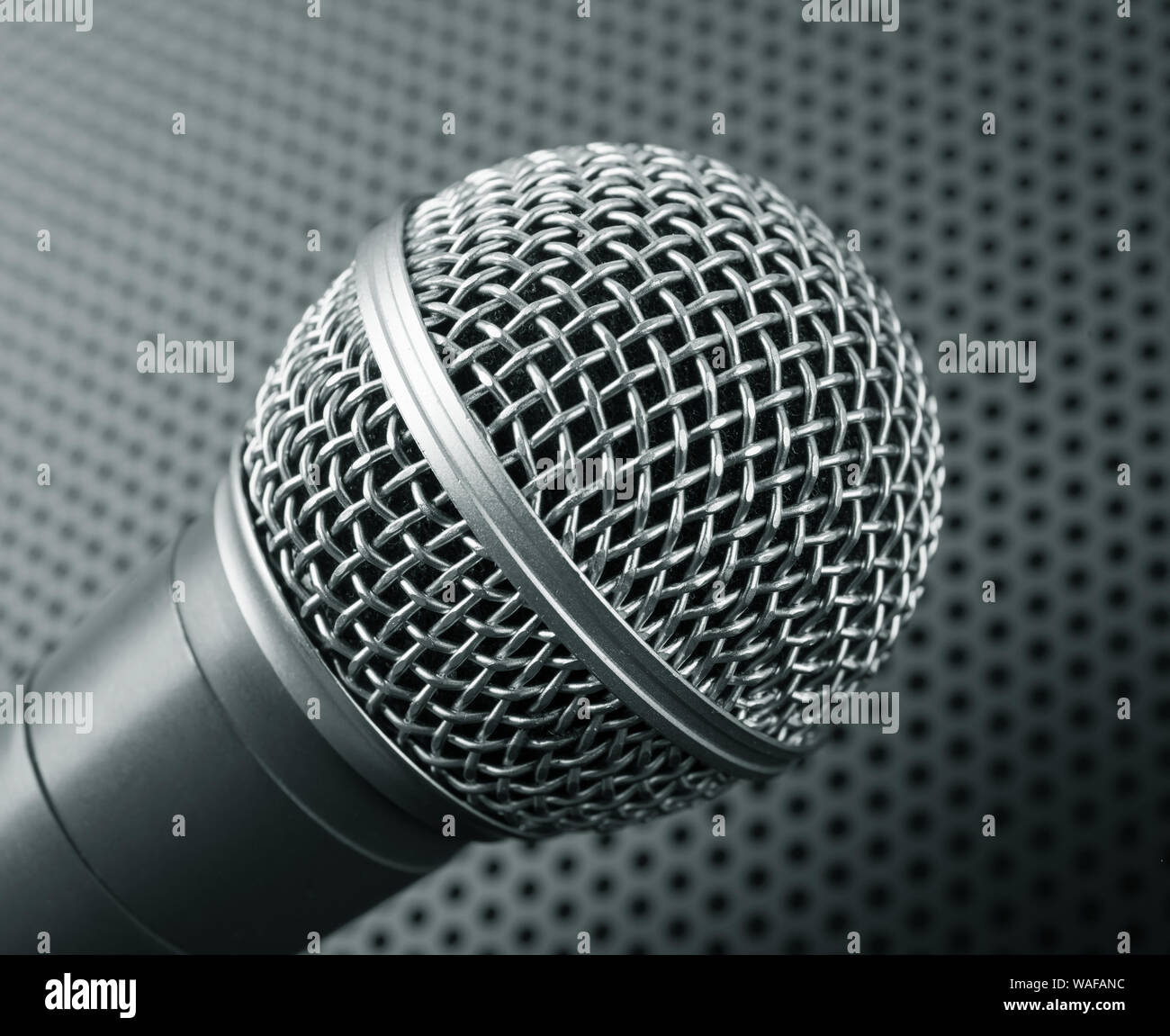Classic dynamic microphone on black background perforated. Toned Stock ...