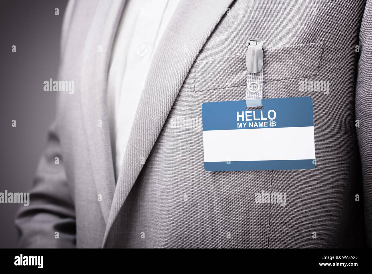 Businessman at an exhibition or conference wearing a Hello my name is ...
