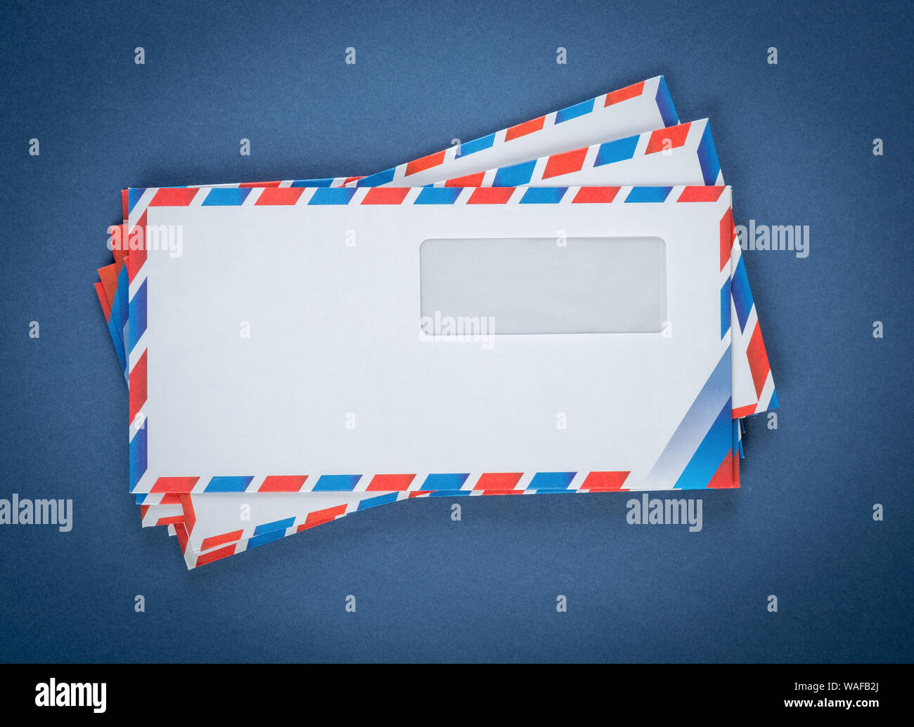 A stack of envelopes on a blue background Stock Photo - Alamy