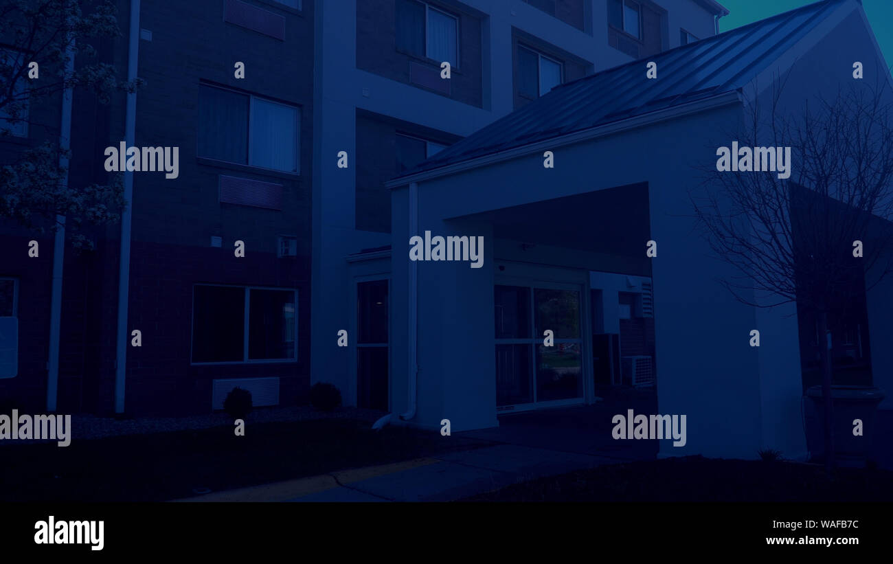 Typical night time exterior establishing shot close up of generic hotel ...