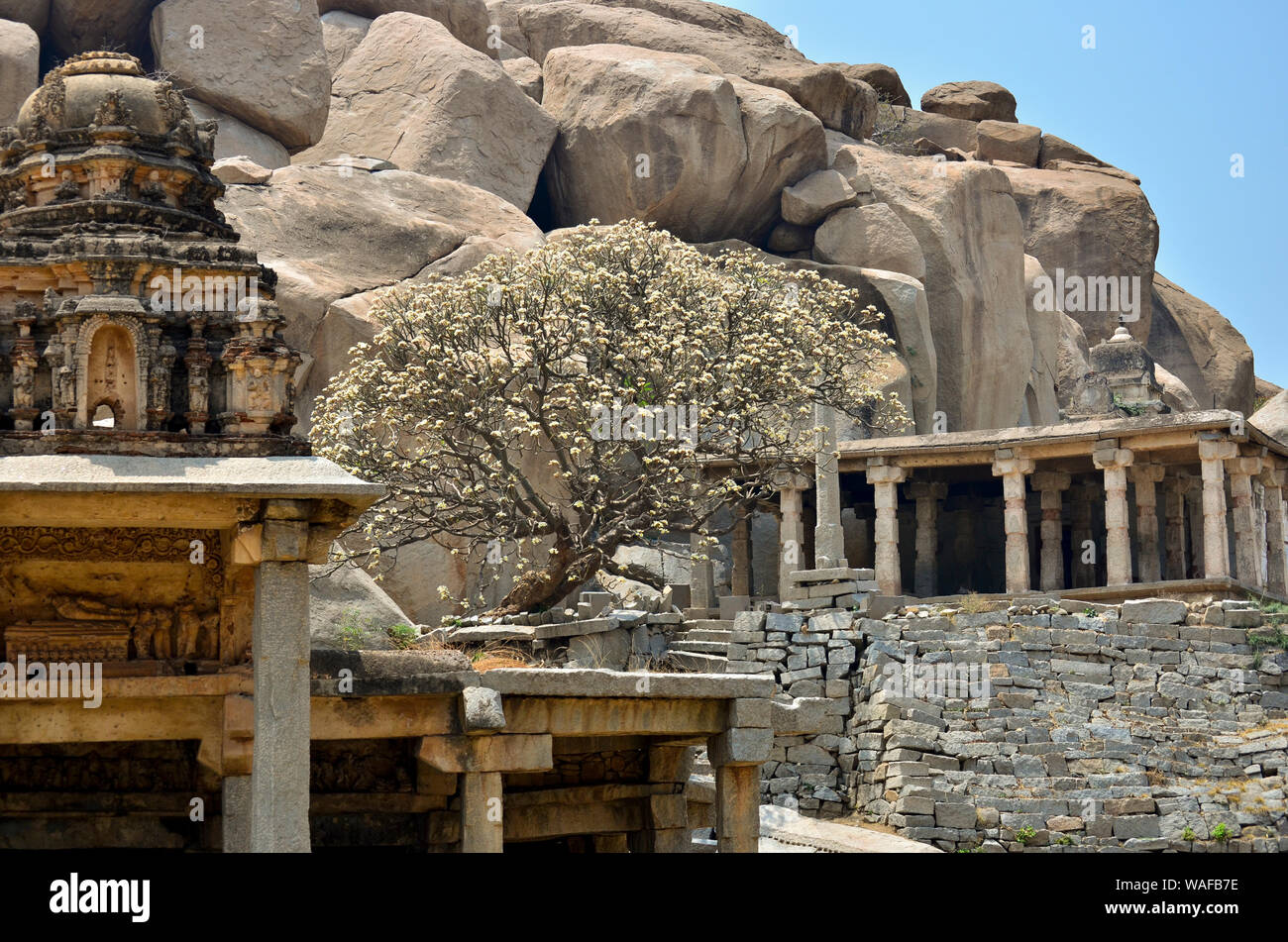 Tree and small stone temples at among rocks in Hampi, Karnataka, India ...