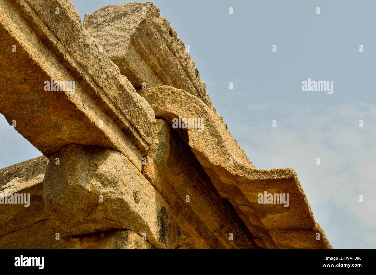 Detail of acient beam and stone column in contrast to the blue sky ...