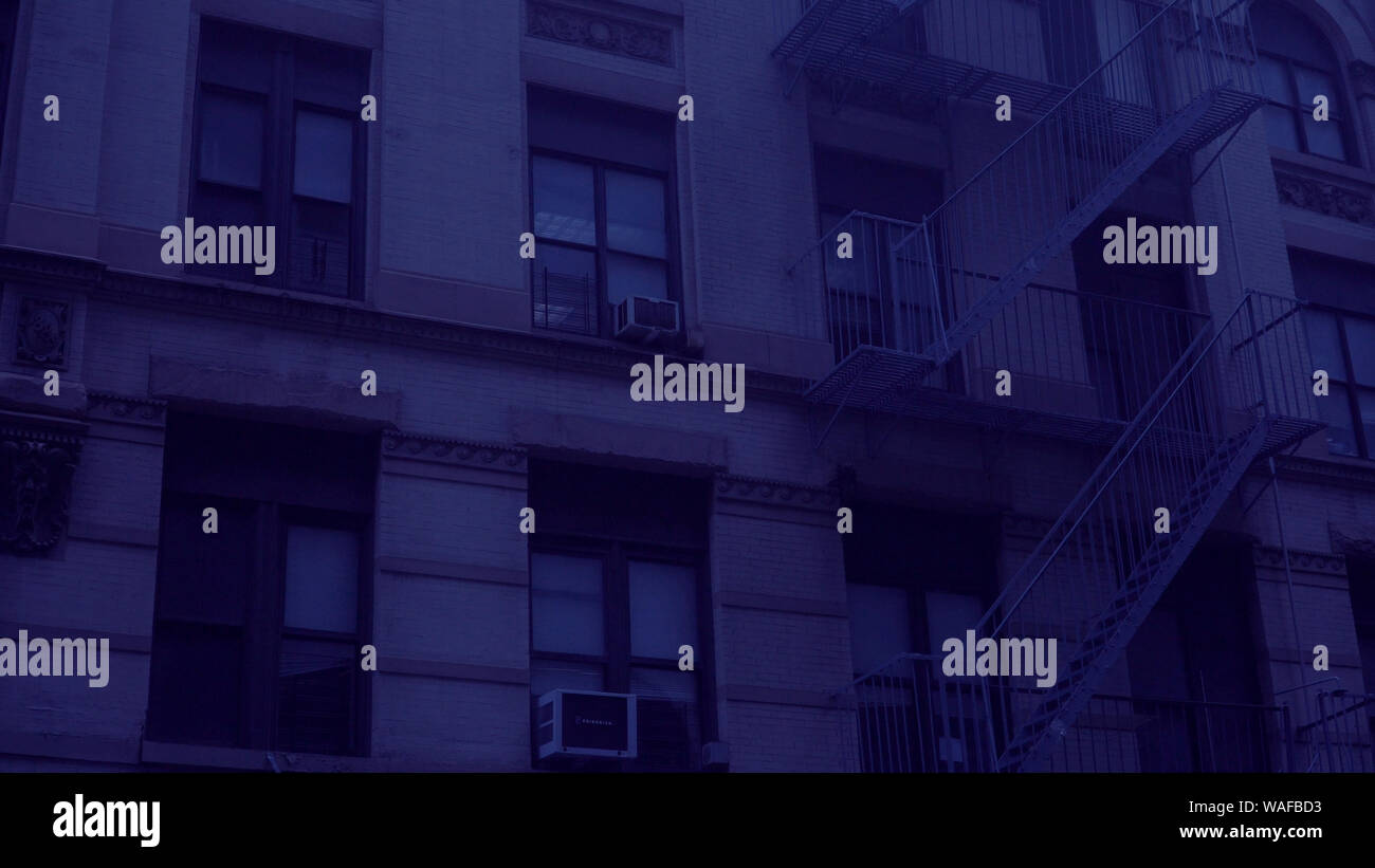 Night time exterior establishing shot outside a typical generic urban ...