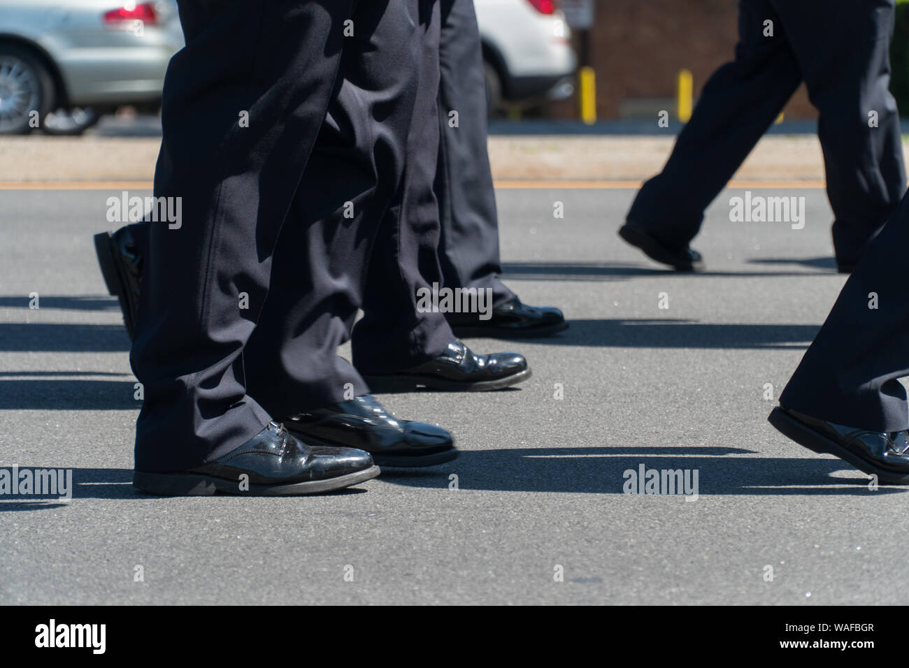Close up view of service men and women legs and feet marching down ...