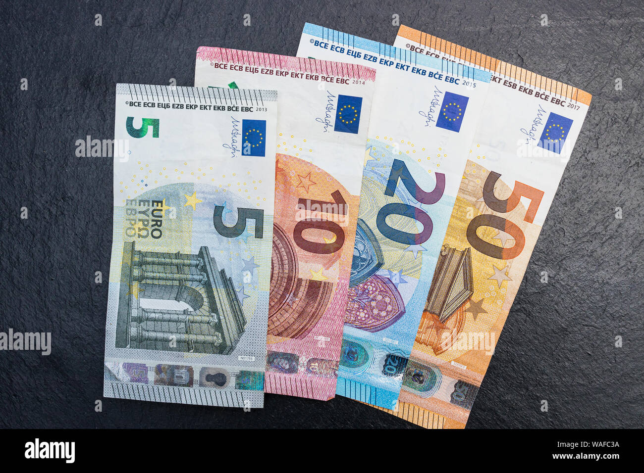 Euro currency cash bank notes money dark background Stock Photo - Alamy