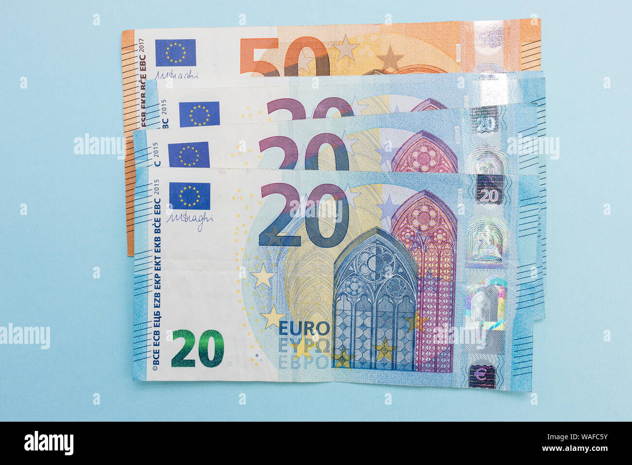 Euro currency cash bank notes money blue background Stock Photo - Alamy
