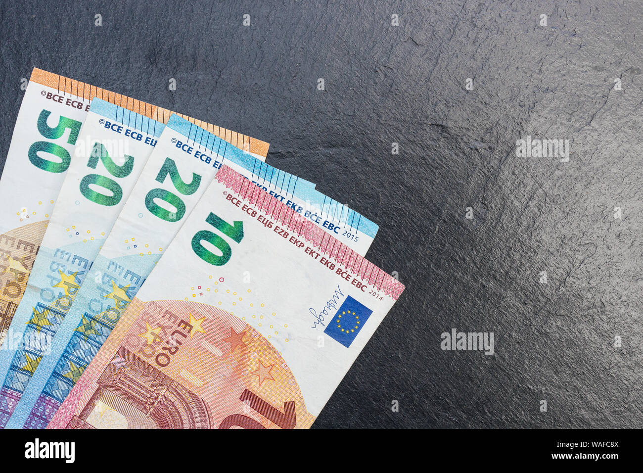Euro currency cash bank notes money dark background Stock Photo - Alamy