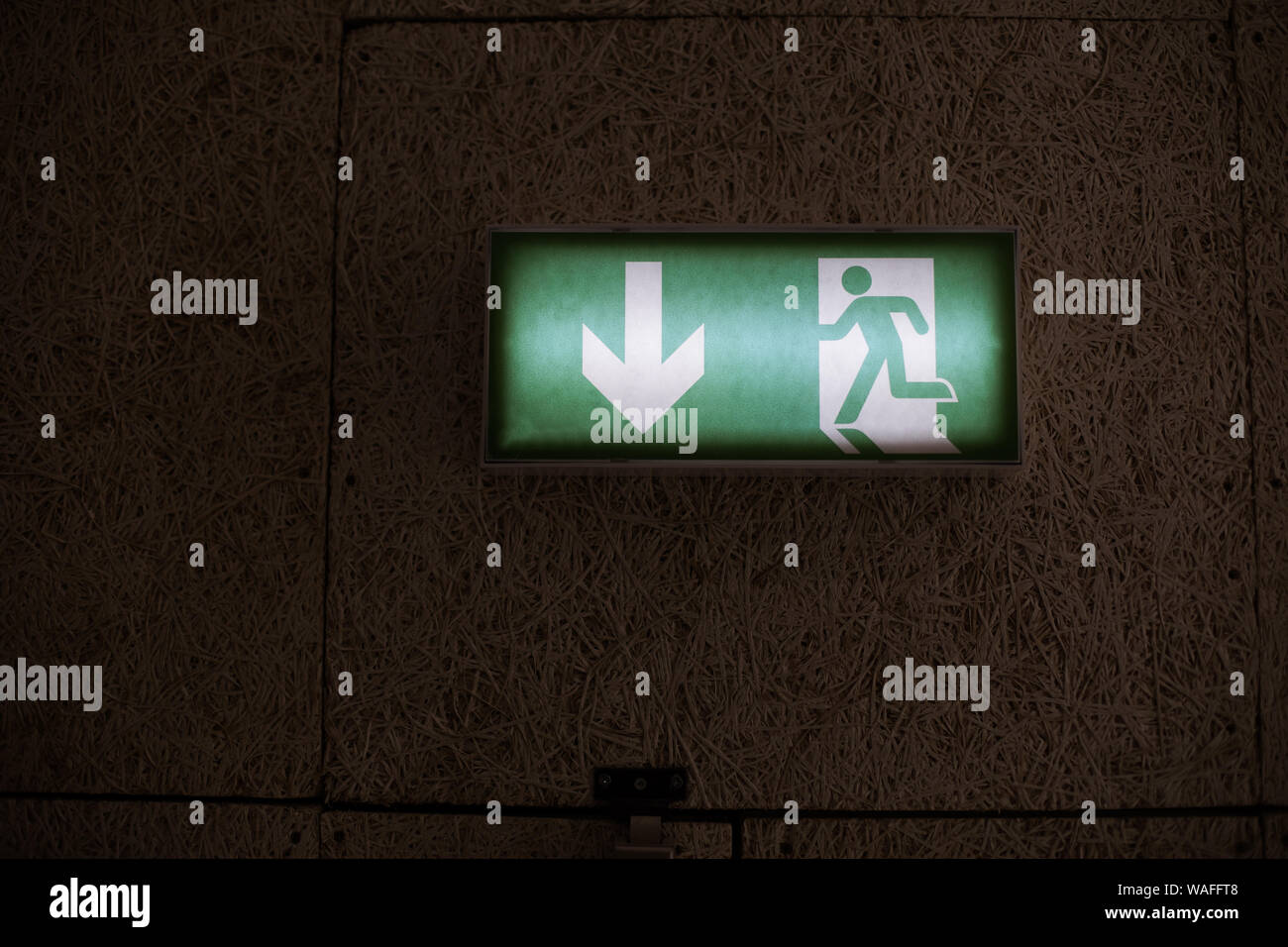 Color image of a green exit sign above a door Stock Photo - Alamy