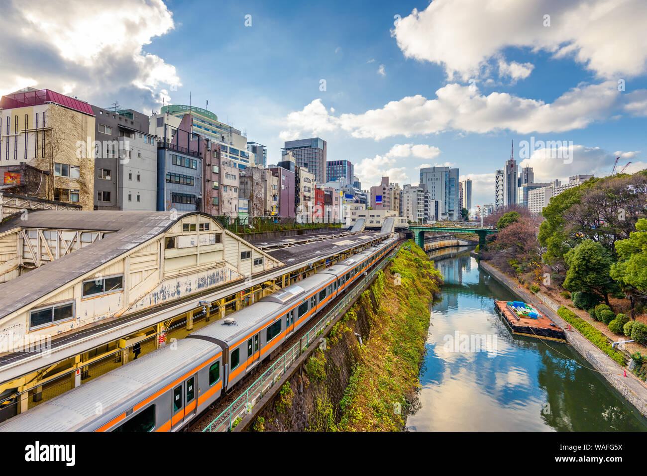 Trains pass by the Kanda River in the Ochanomizu district of Tokyo ...