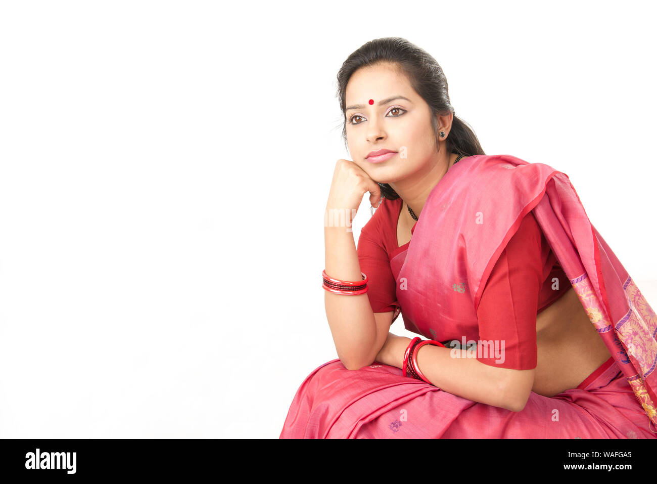 Young indian woman thinking sitting hi-res stock photography and images ...