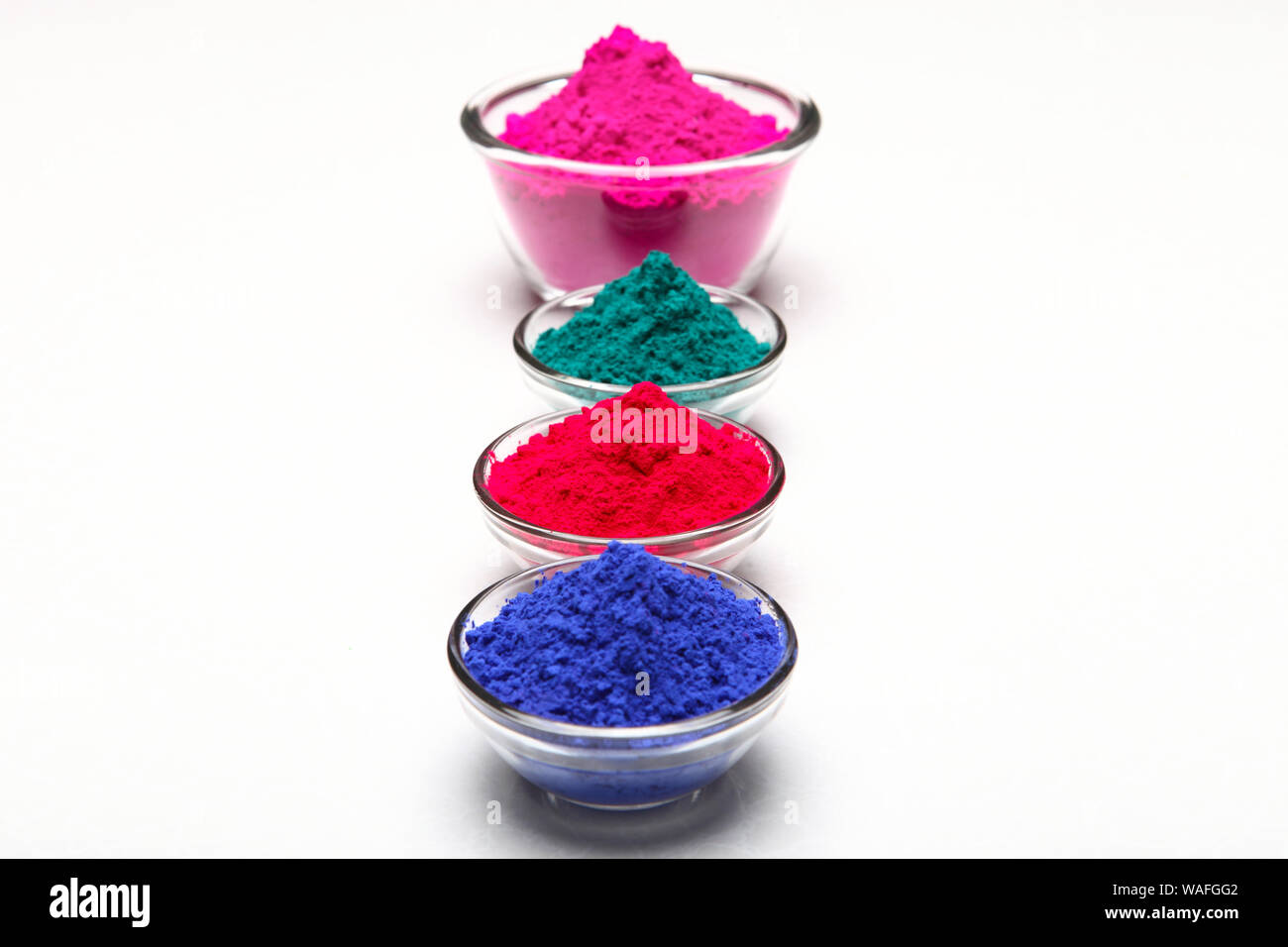 Bowls full of holi color in a row Stock Photo - Alamy
