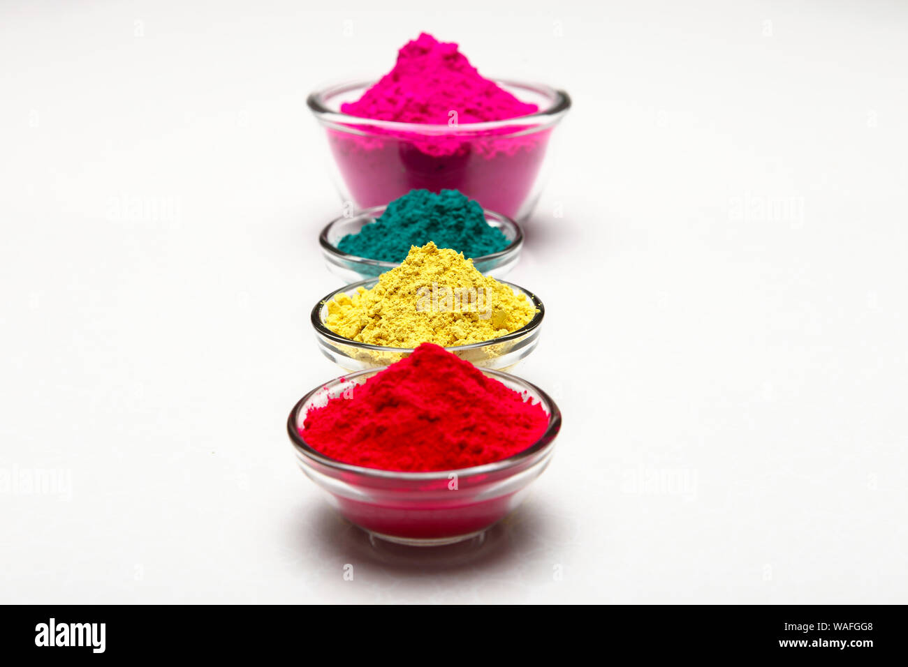 Bowls full of holi color in a row Stock Photo - Alamy