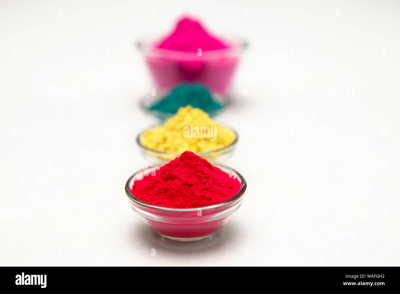 Bowls full of holi color in a row Stock Photo - Alamy
