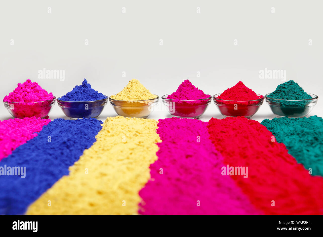 Bowls full of holi color in a row Stock Photo - Alamy
