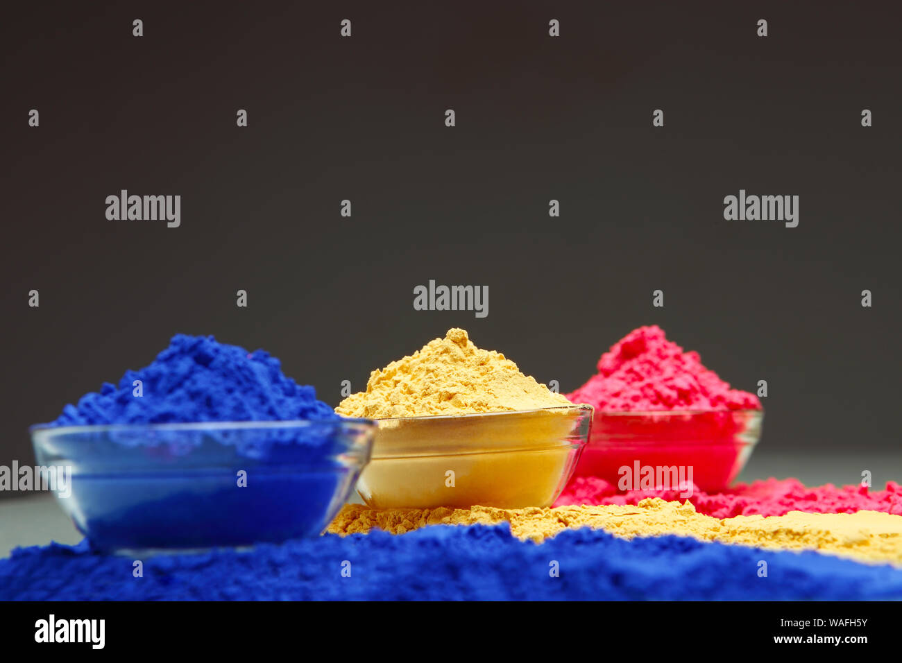 Bowls full of holi color in a row Stock Photo - Alamy
