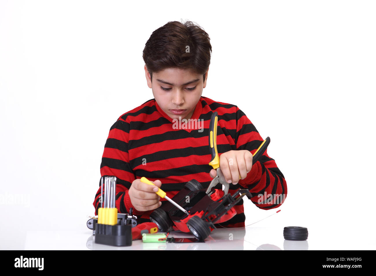 Boy repairing his toy car Stock Photo - Alamy