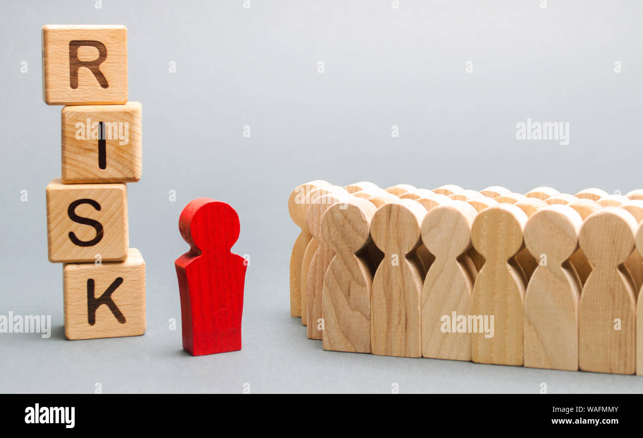 Wooden blocks with the word Risk and a team with a leader. Business ...