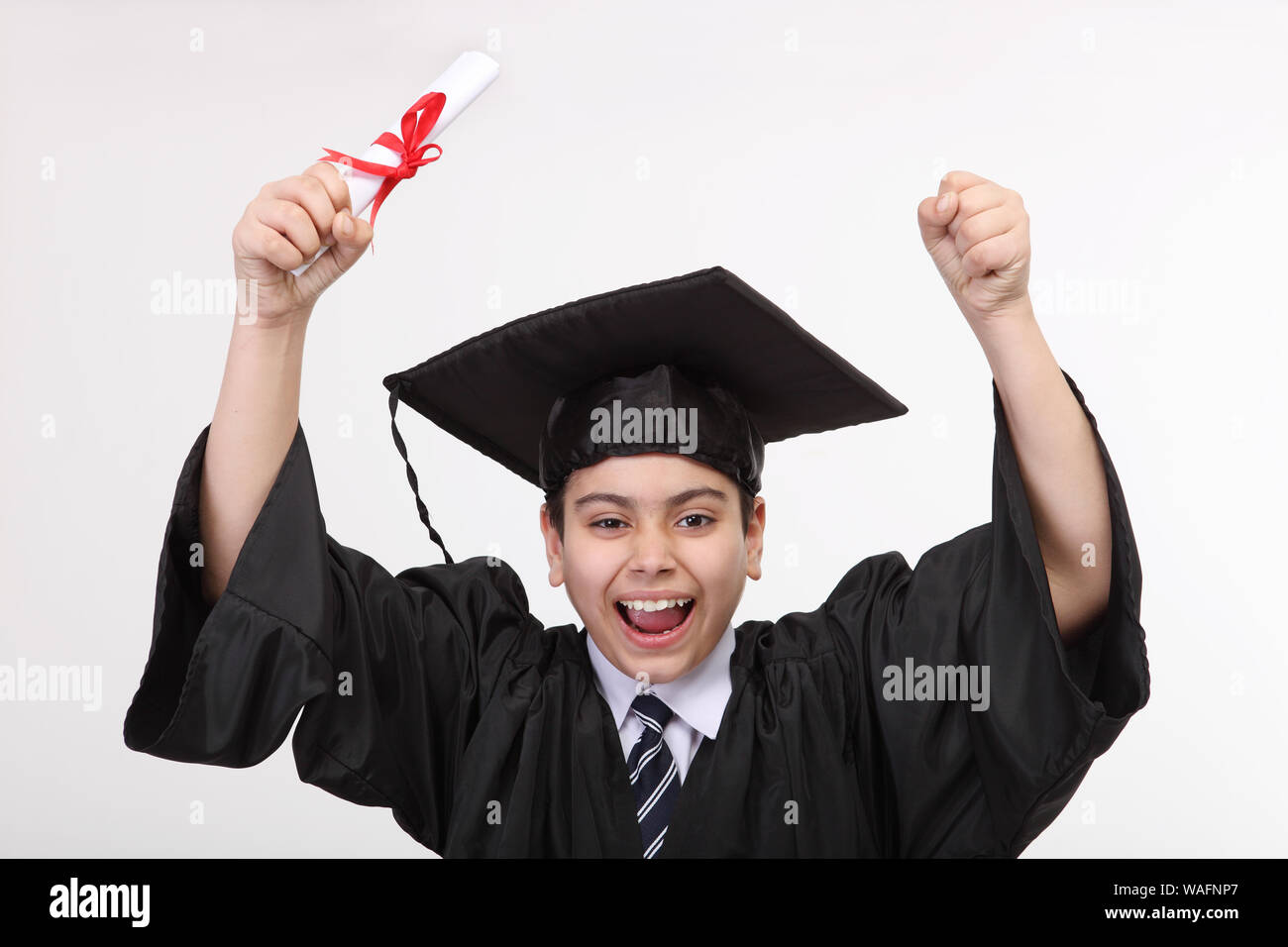 Indian boy in graduation gown showing a degree Stock Photo - Alamy