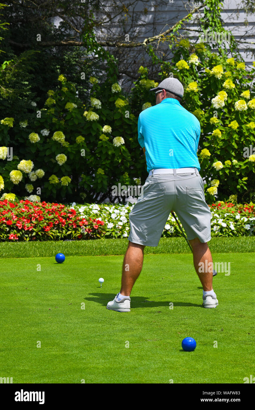 Young Man Looking Down the Fairway Getting Ready to Tee Off WIth a ...