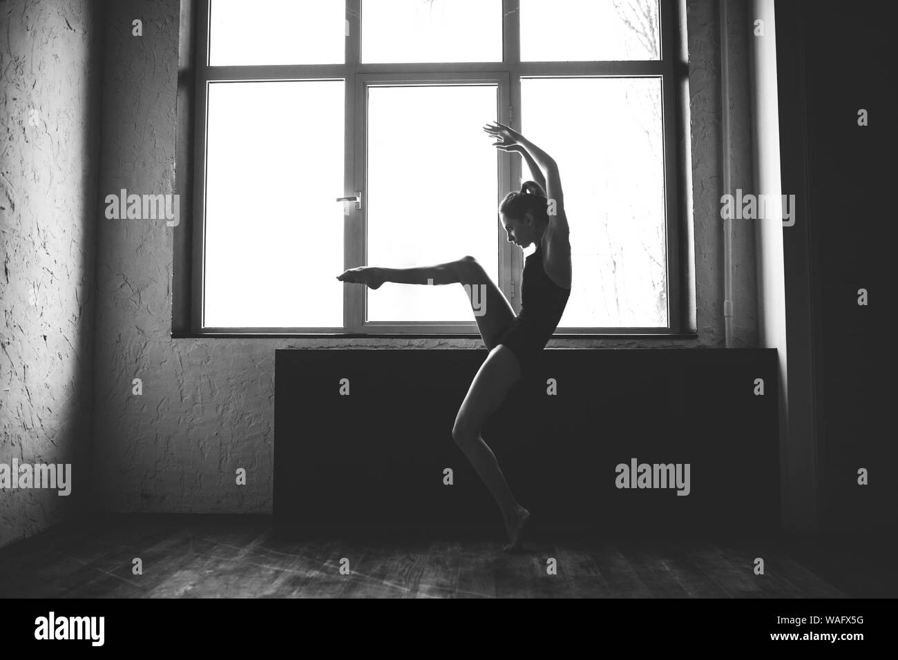 Plasticity slim woman dancing near window. Professional dancer enjoy ...