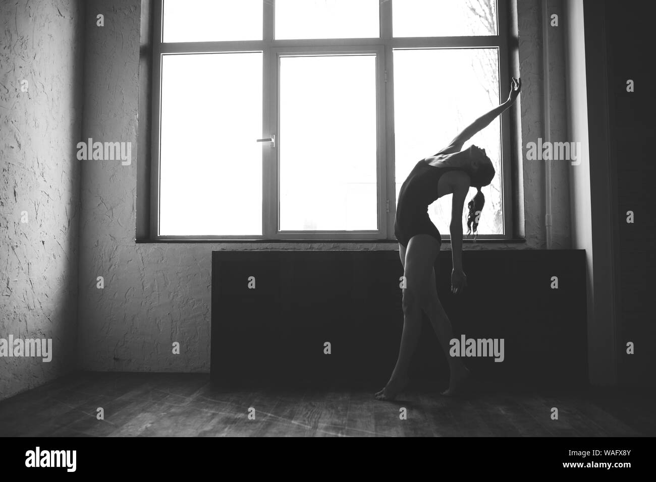 Plasticity slim woman dancing near window. Professional dancer enjoy ...