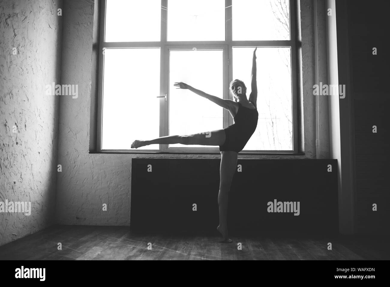 Plasticity slim woman dancing near window. Professional dancer enjoy ...