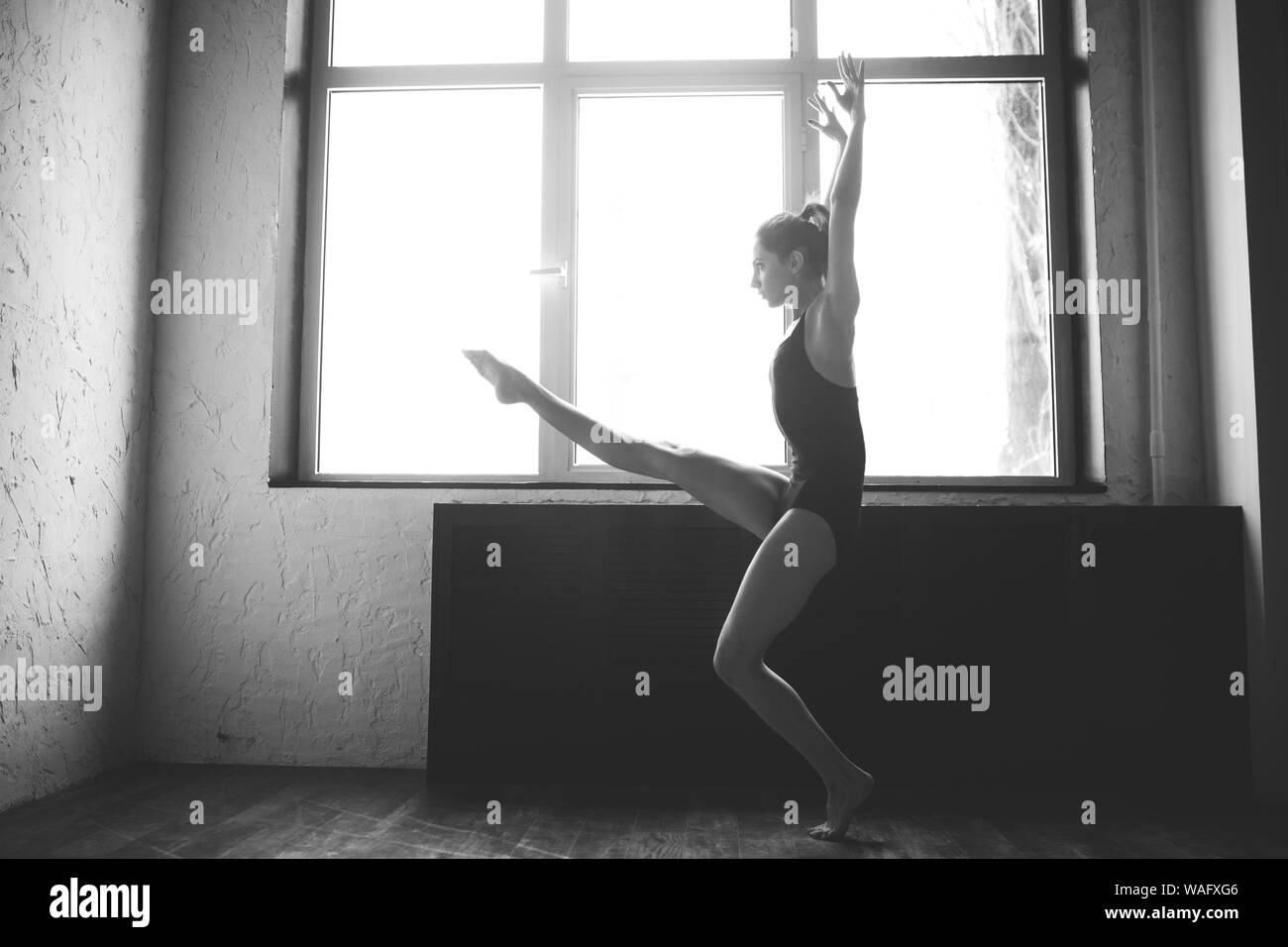 Plasticity slim woman dancing near window. Professional dancer enjoy ...