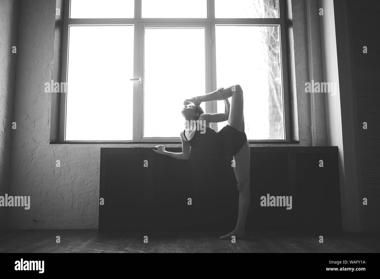 Plasticity slim woman dancing near window. Professional dancer enjoy ...
