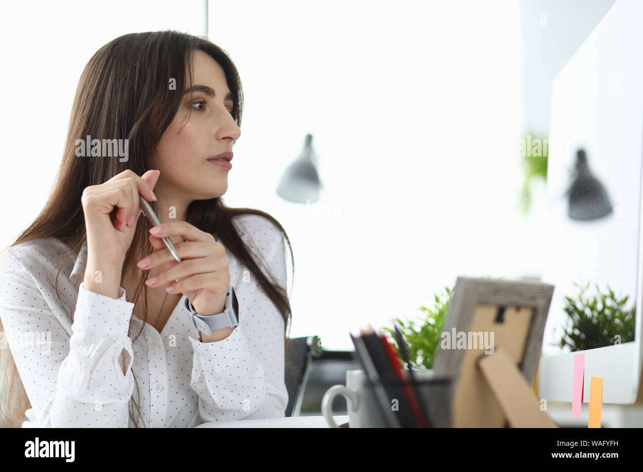 Cute lady thinking about project Stock Photo - Alamy