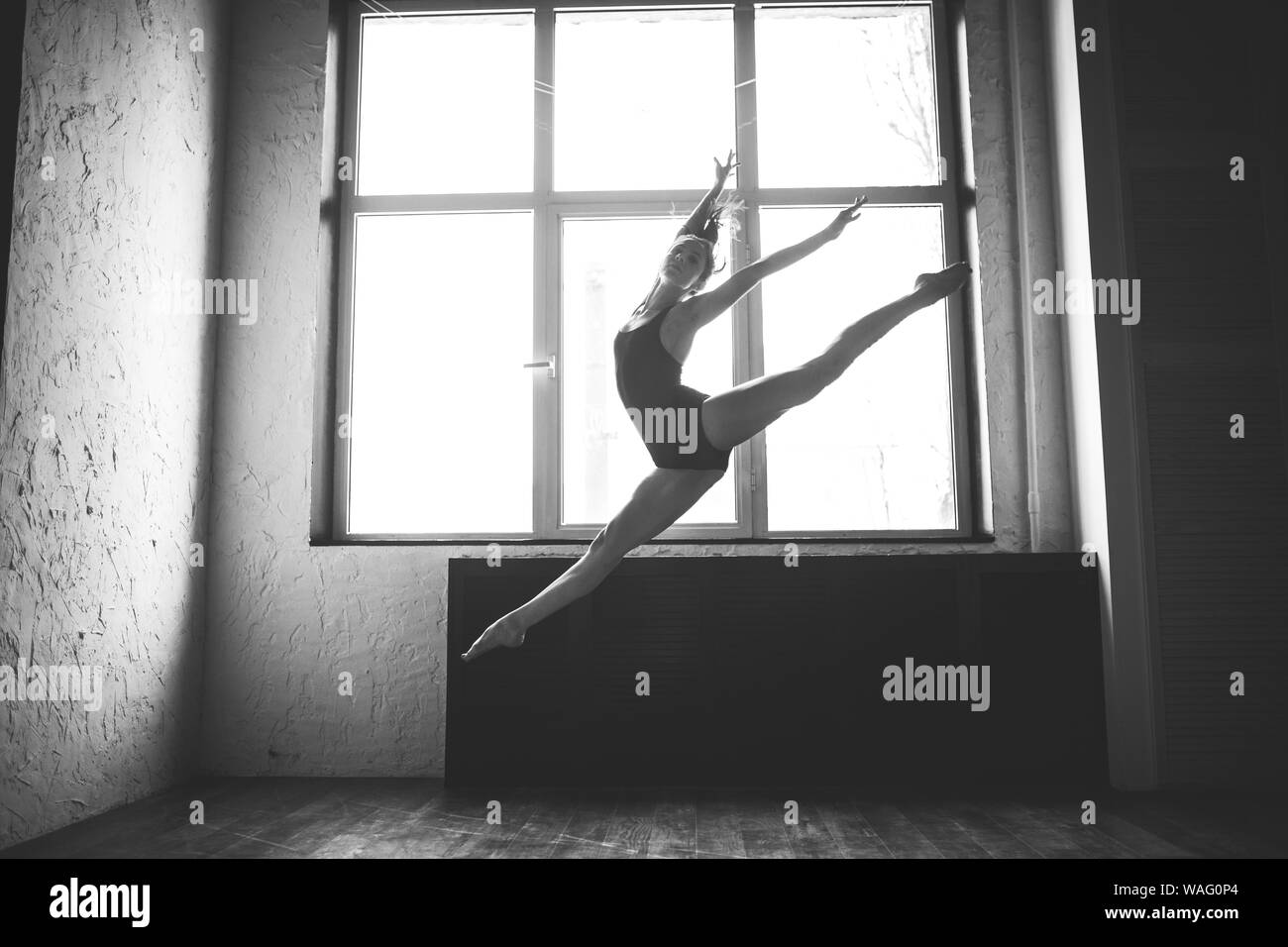 Plasticity slim woman dancing near window. Professional dancer enjoy ...